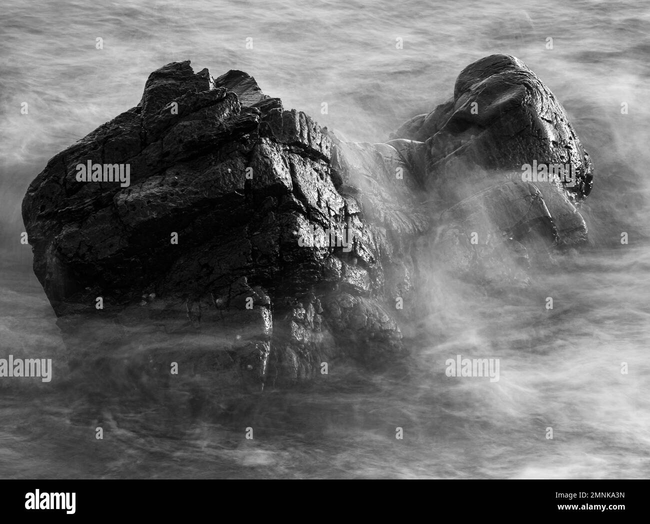 Long exposure of the sea water rushing around the rocks near the ...