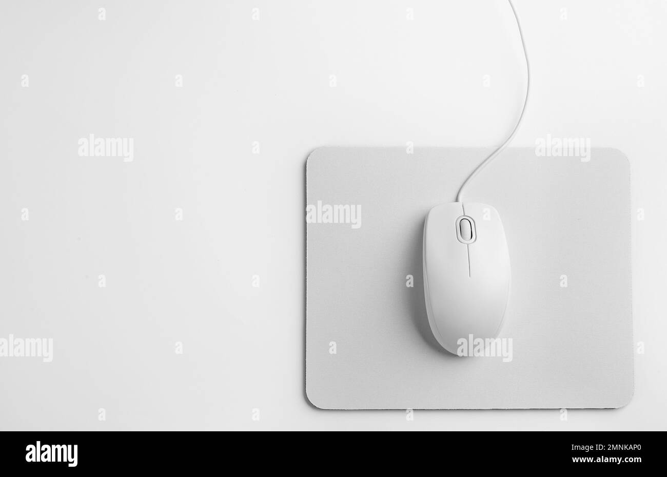 Modern wired optical mouse and pad on white background, top view Stock ...