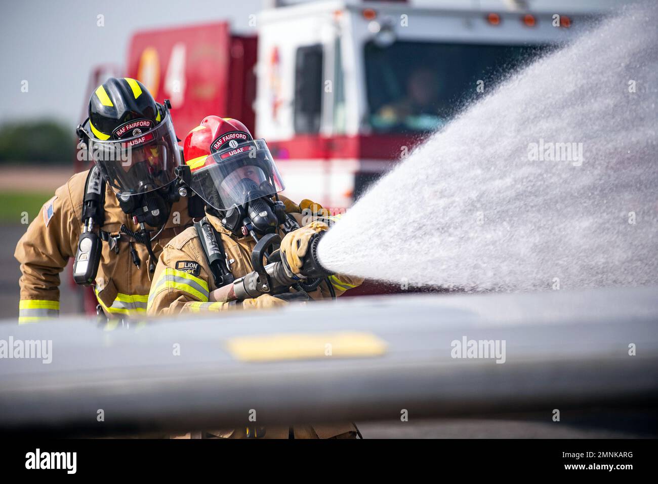 Firefighters from the 422d Fire Emergency Services extinguish an ...