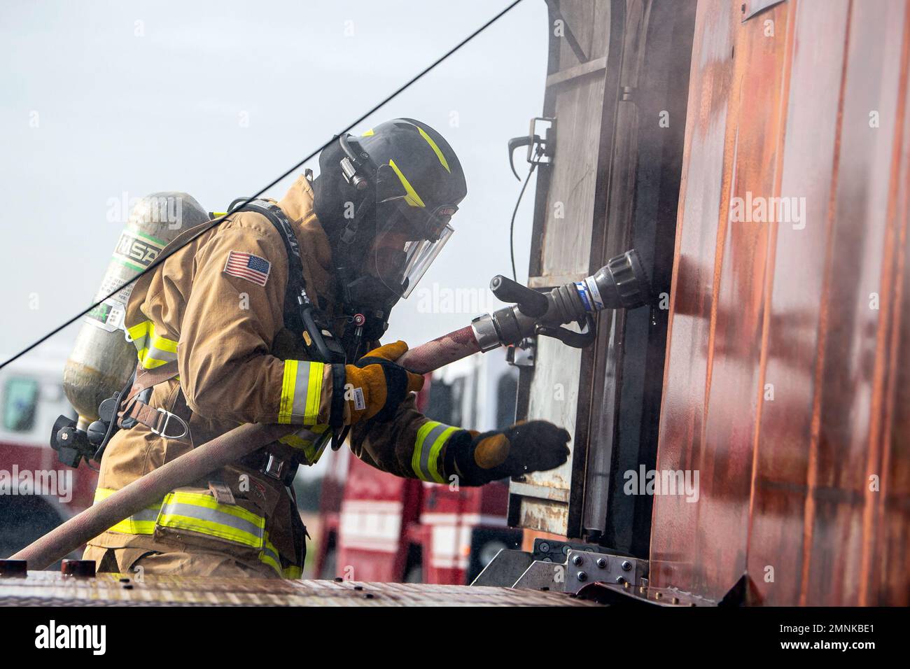 A firefighter from the 422d Fire Emergency Services, climbs into the ...