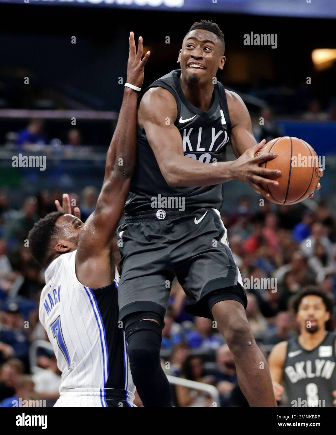 Brooklyn Nets' Caris LeVert, right, goes over Orlando Magic's Shelvin ...