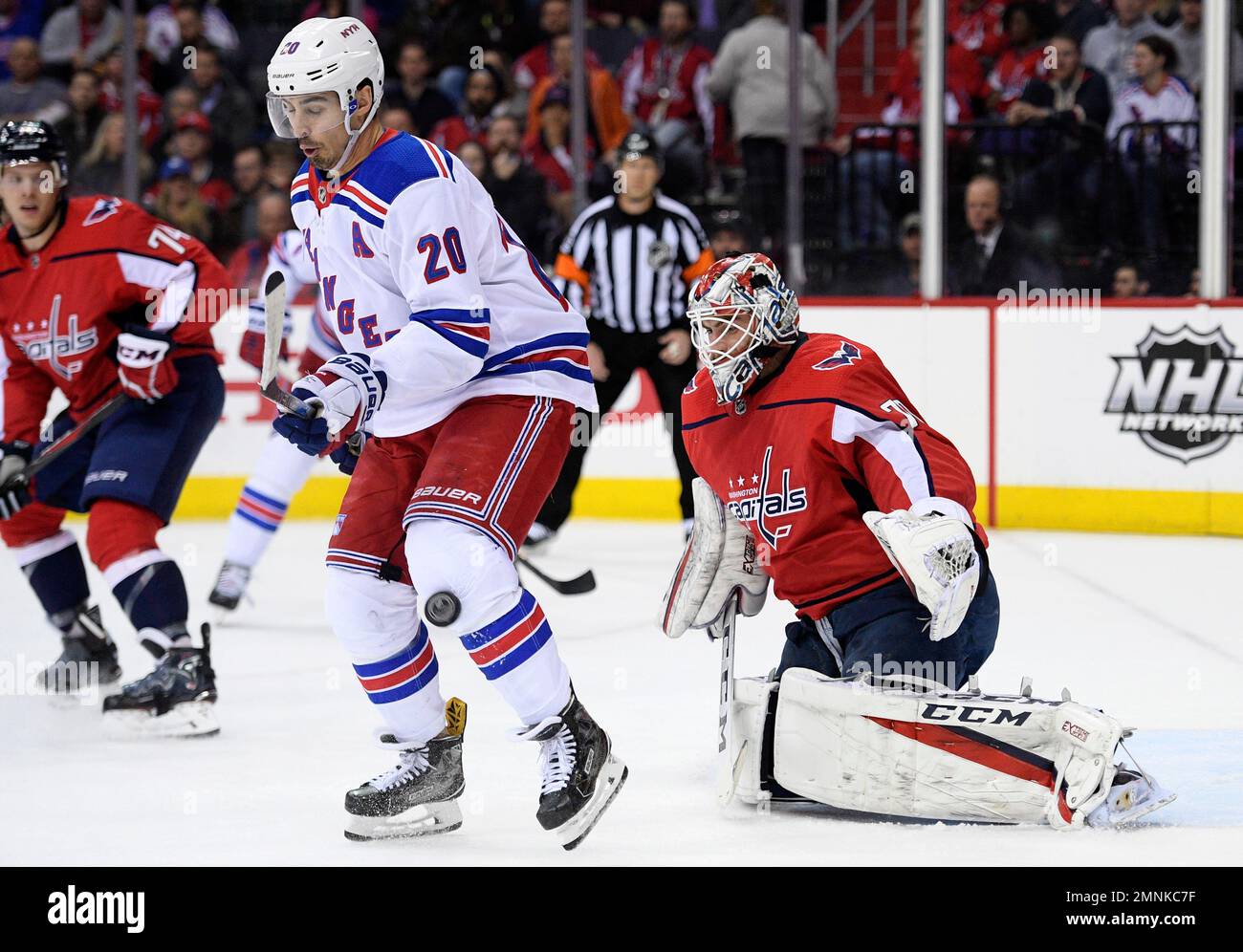 New York Rangers left wing Chris Kreider (20) gets hit with the puck as ...