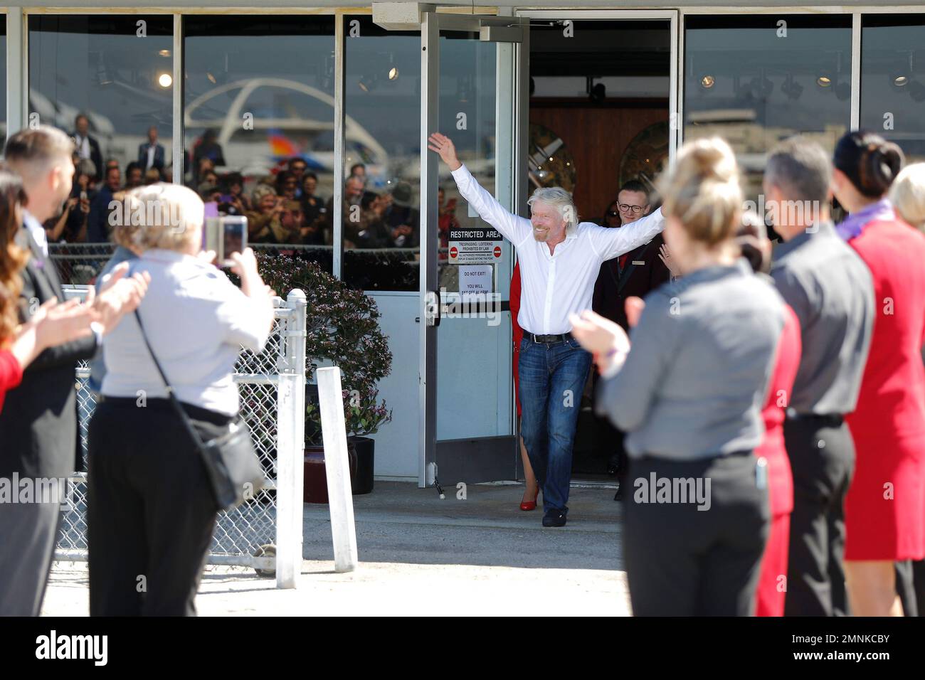 Virgin Group founder Richard Branson, center, is greeted by Virgin ...