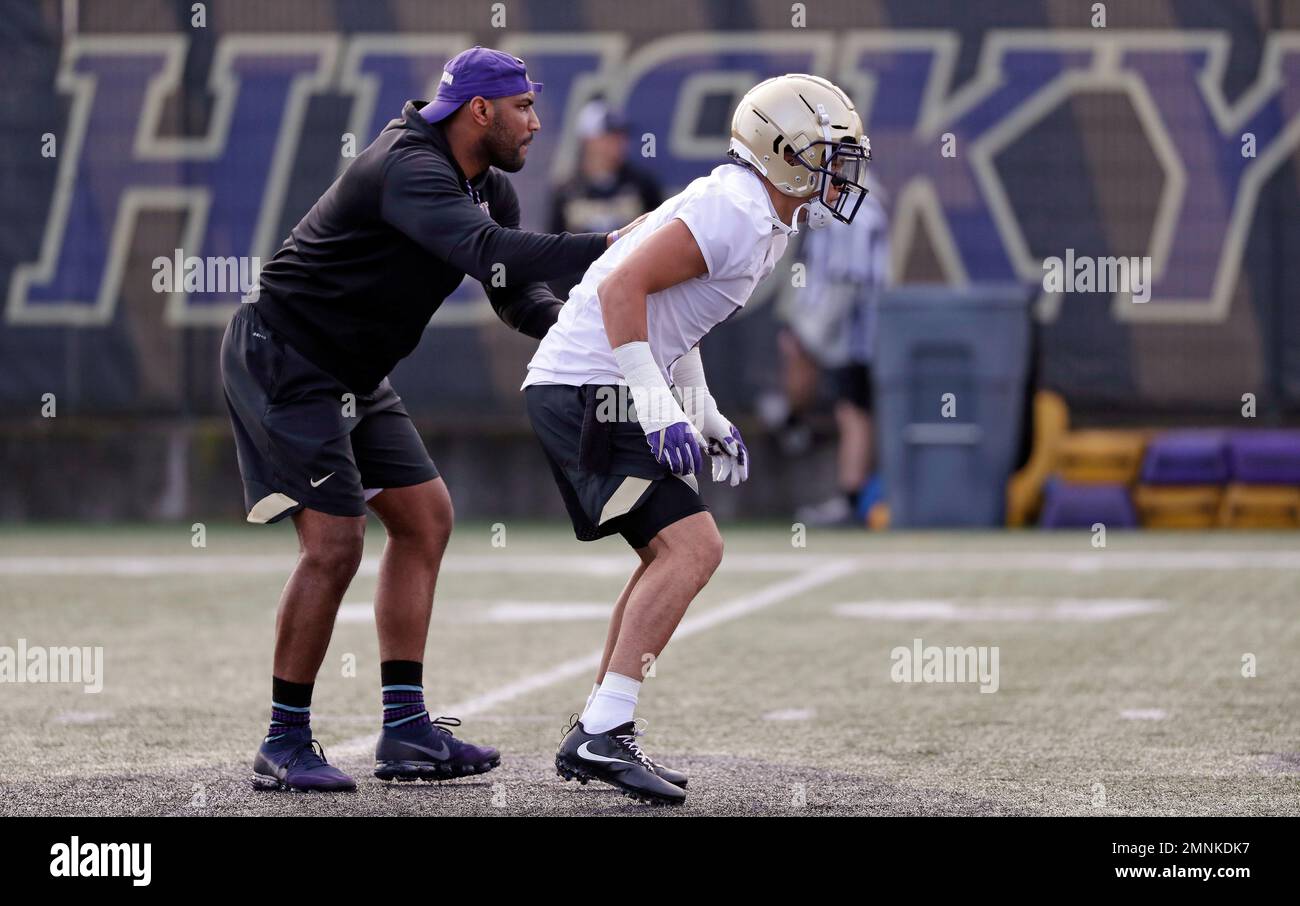 Washington assistant defensive backs coach Will Harris, left, directs ...