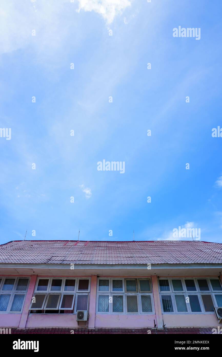 Old school building on blue sky background. Portrait photo Stock Photo ...