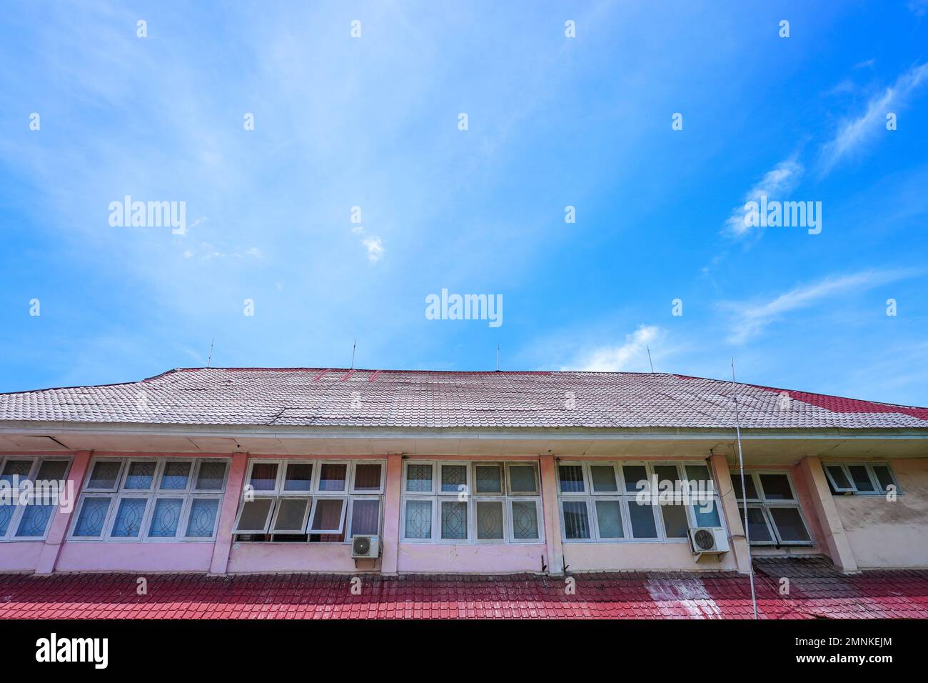 Old school building on blue sky background Stock Photo - Alamy