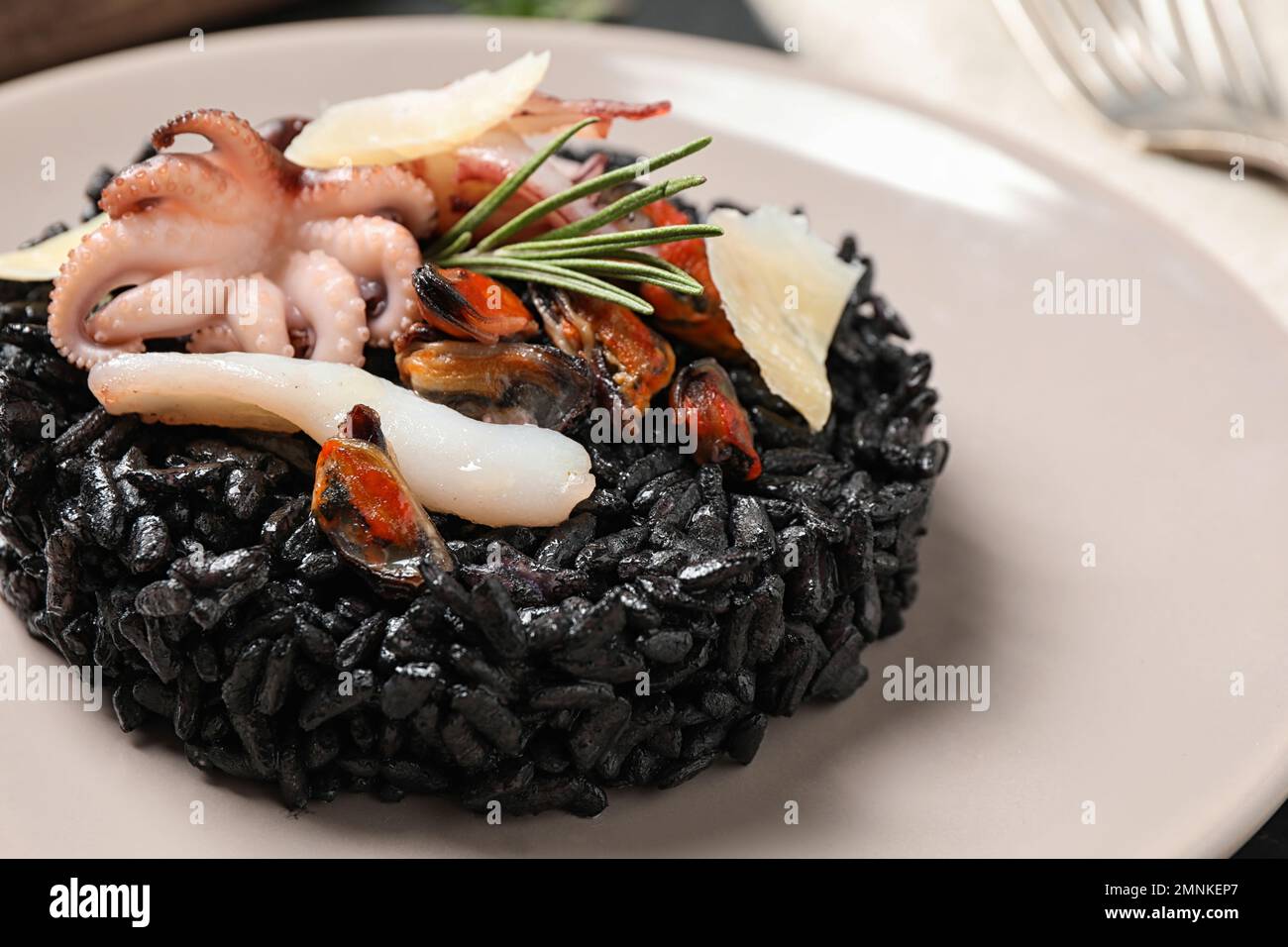 Delicious black risotto with seafood in plate, closeup Stock Photo - Alamy