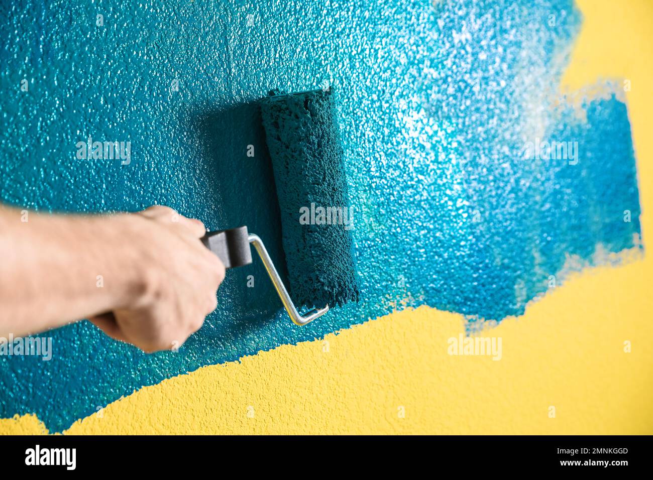 Man hand roller painting yellow hi-res stock photography and images - Alamy