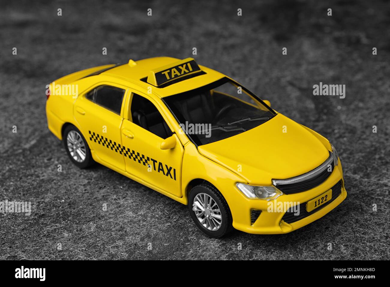 Yellow taxi car model on grey background Stock Photo - Alamy