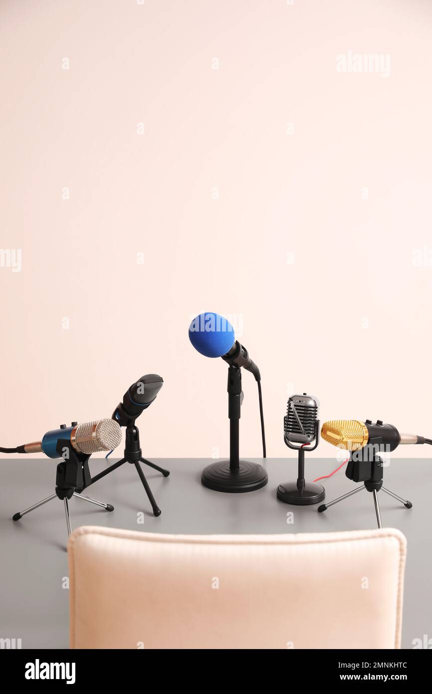 Microphones on light grey table in conference hall. Journalist's work ...