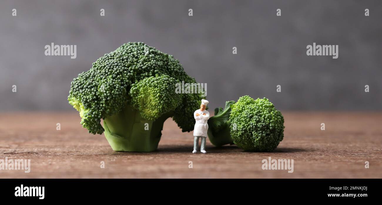 Fresh broccoli and a miniature chef. Fresh greens and miniature people ...