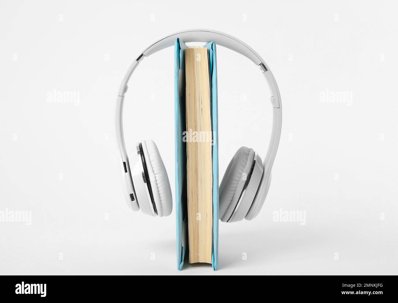 Book and modern headphones isolated on white Stock Photo - Alamy
