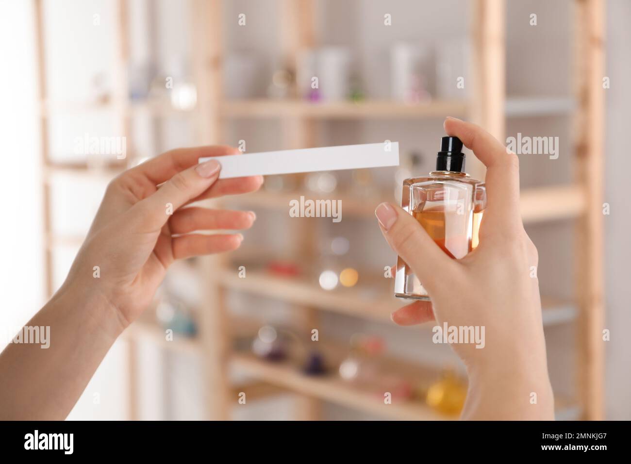 Woman spray perfume tester hi-res stock photography and images - Alamy