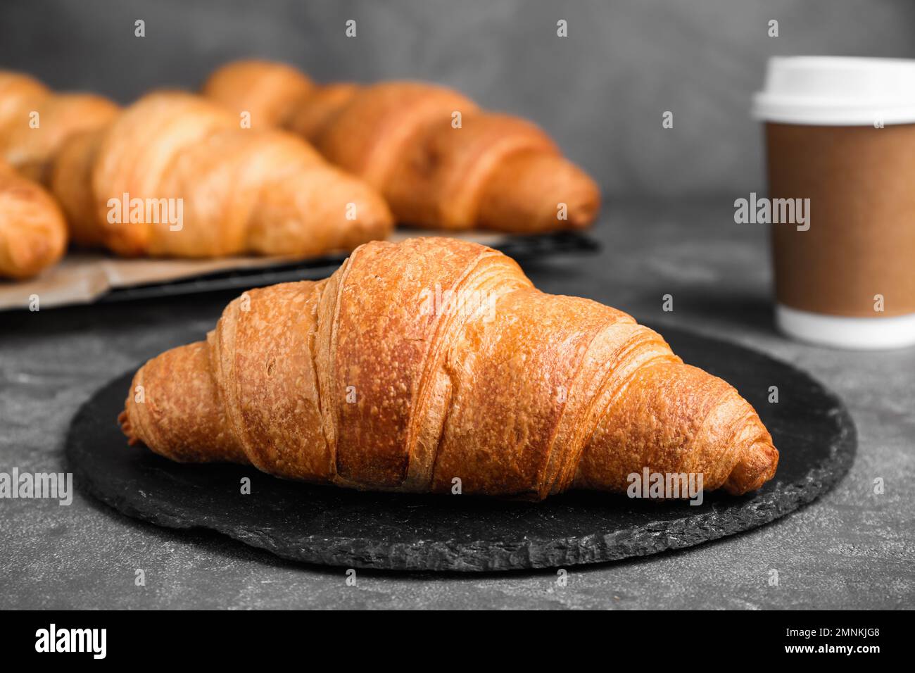 Tasty fresh crispy croissants on grey table Stock Photo - Alamy