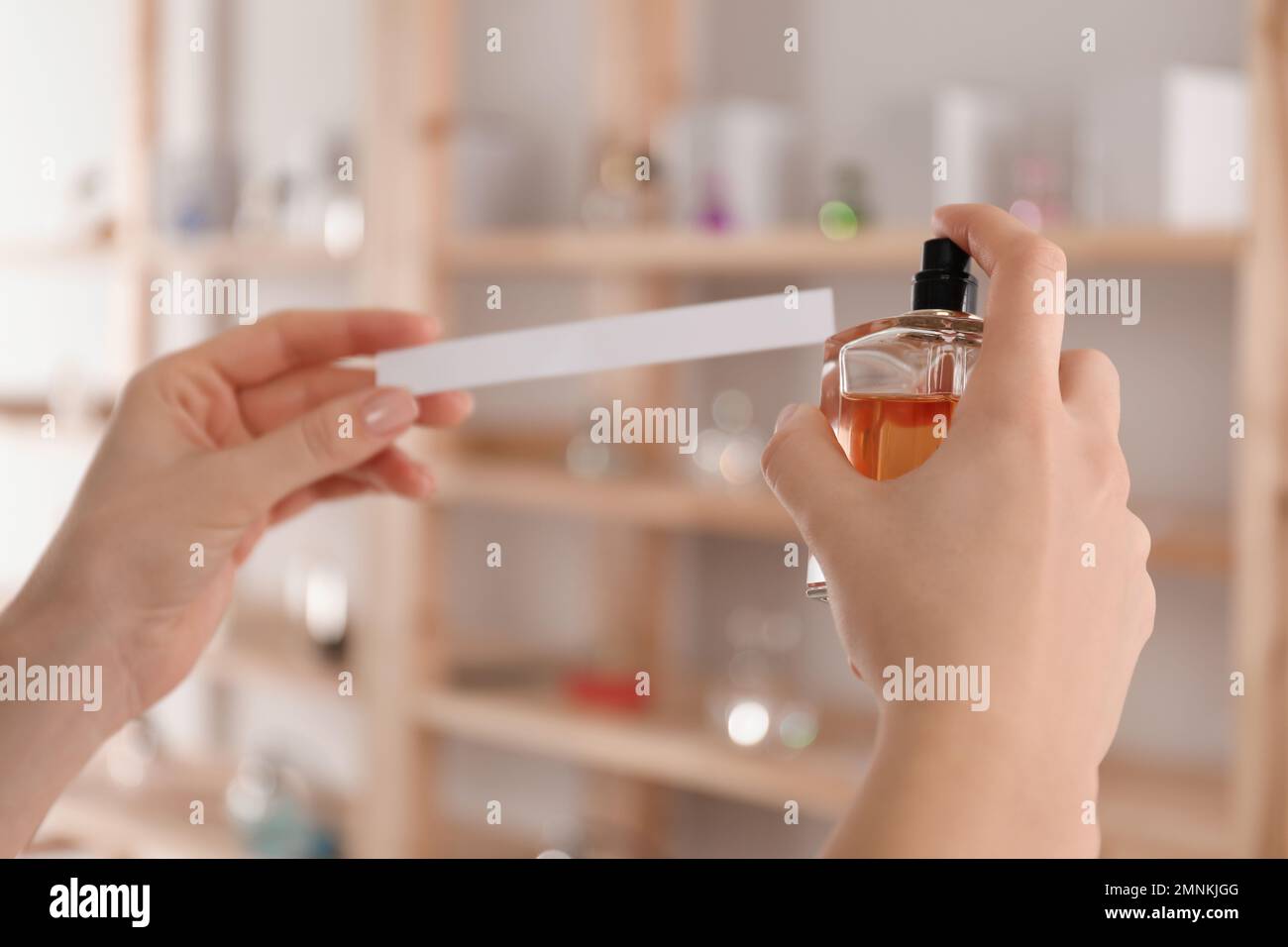 Woman spray perfume tester hi-res stock photography and images - Alamy