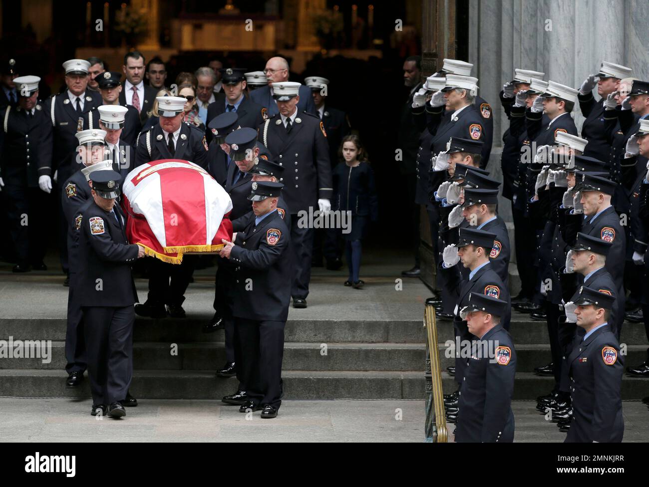 Firefighters salute as a casket containing the body of firefighter ...