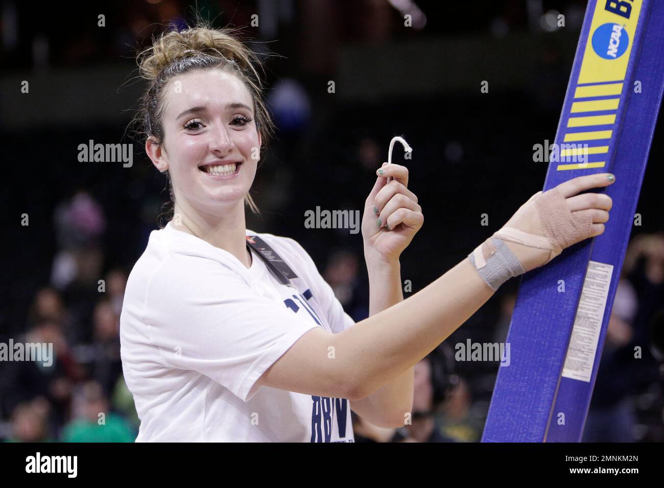 Notre Dame guard Marina Mabrey holds a piece of the net after her team ...