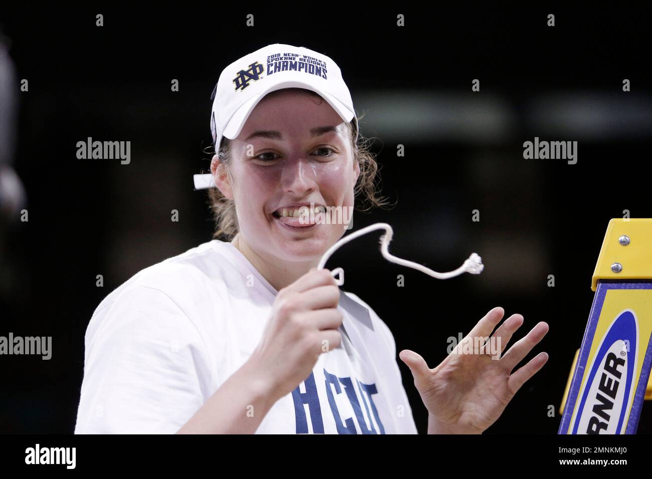 Notre Dame forward Jessica Shepard holds a piece of the net she cut ...