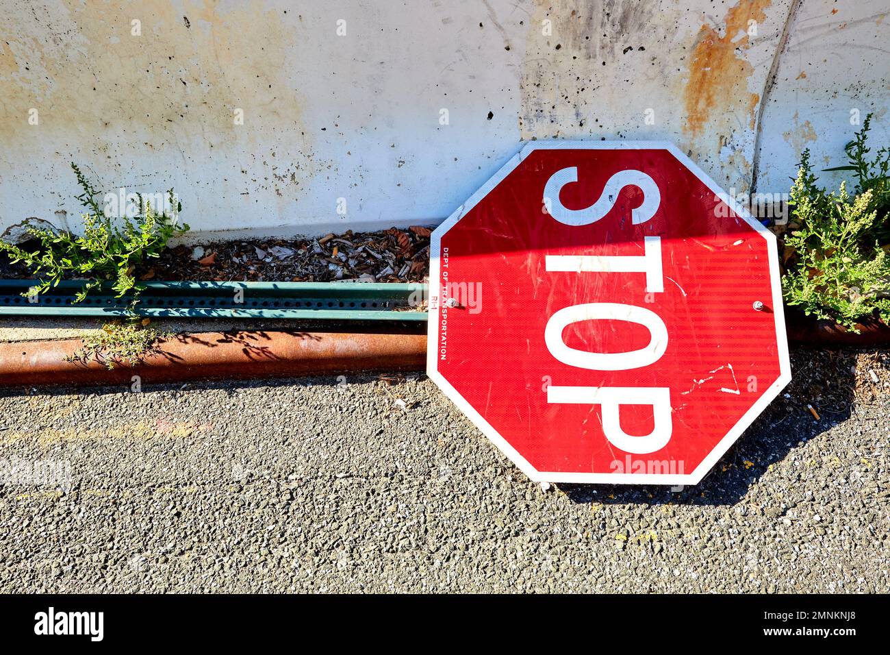 Stop Sign Laying on the Street Next to Barrier, Right of Frame Stock ...