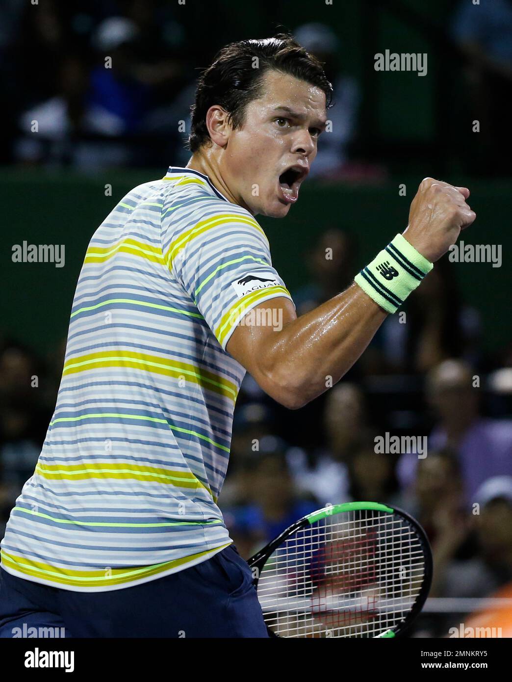 Milos Raonic, of Canada, celebrates after winning the first set during ...
