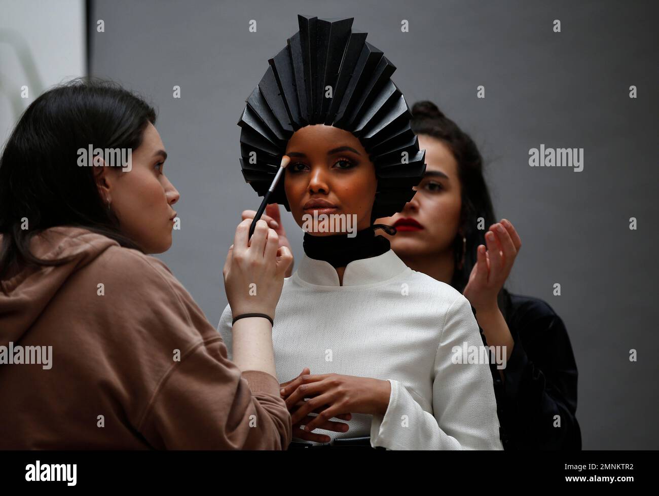 Assistants prepare Halima Aden, a hijab wearing model from the United ...