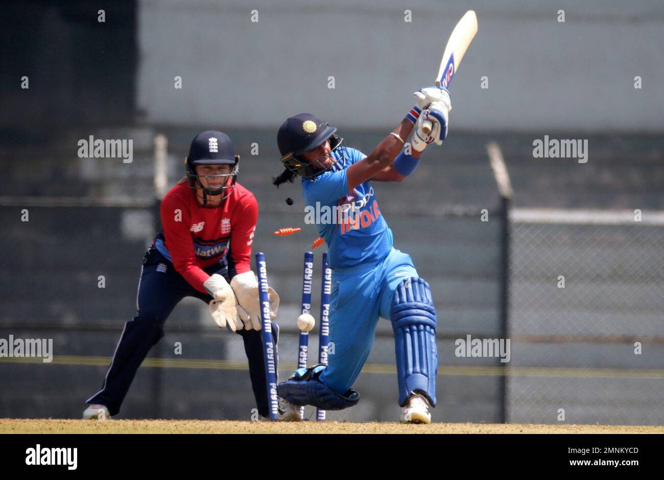 Indian Harmanpreet Kaur is bowled by England's Natasha Farrant during ...