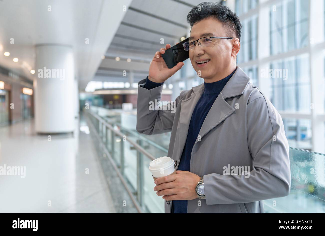 Business man make a phone call at the airport Stock Photo - Alamy
