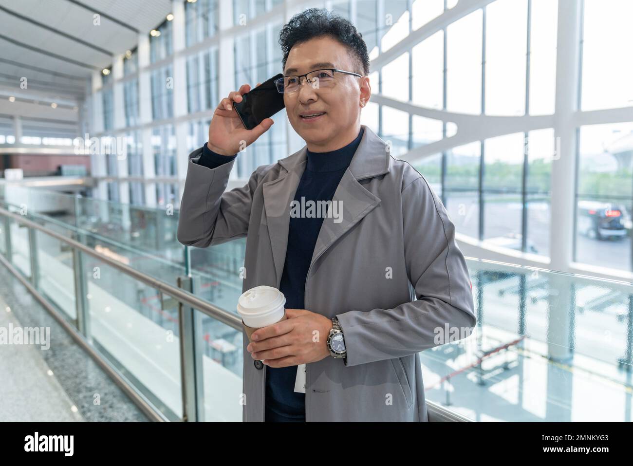 Business man make a phone call at the airport Stock Photo - Alamy