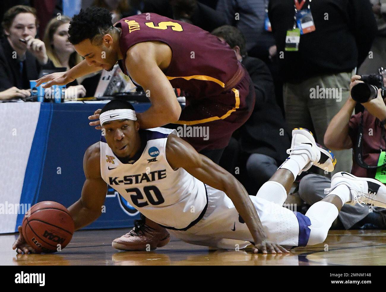 Kansas State forward Xavier Sneed (20) and Loyola-Chicago guard Marques ...