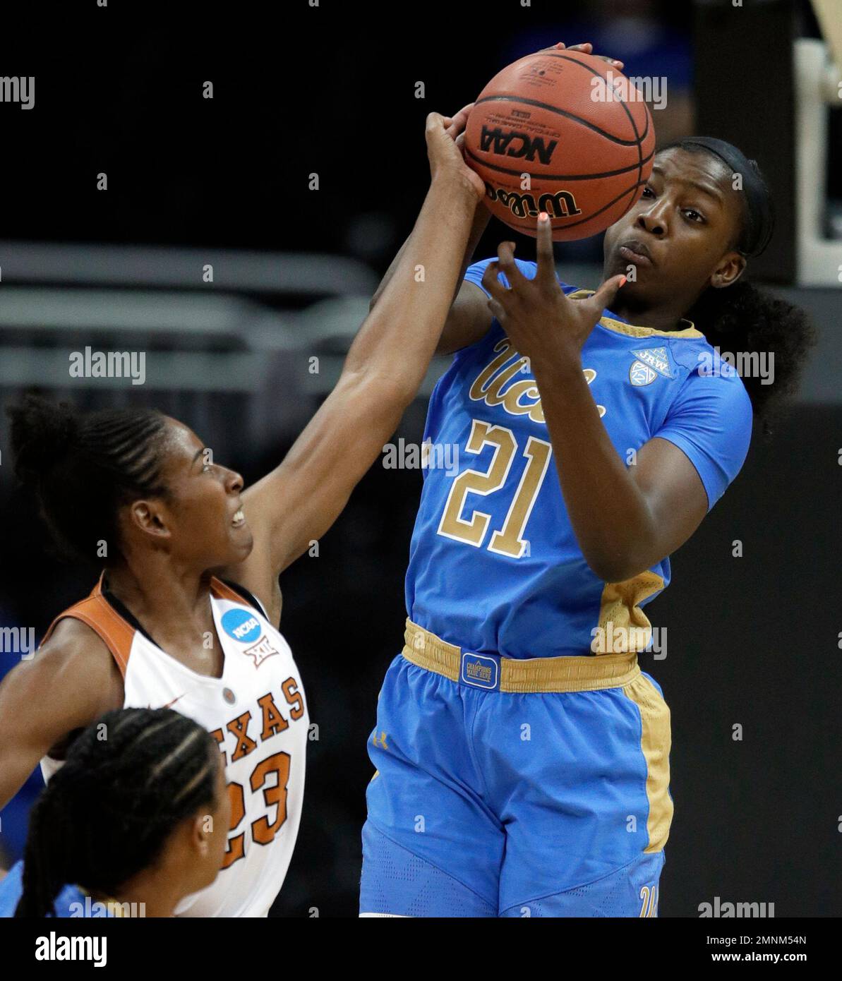 UCLA forward Michaela Onyenwere (21) pulls in a rebound against Texas ...