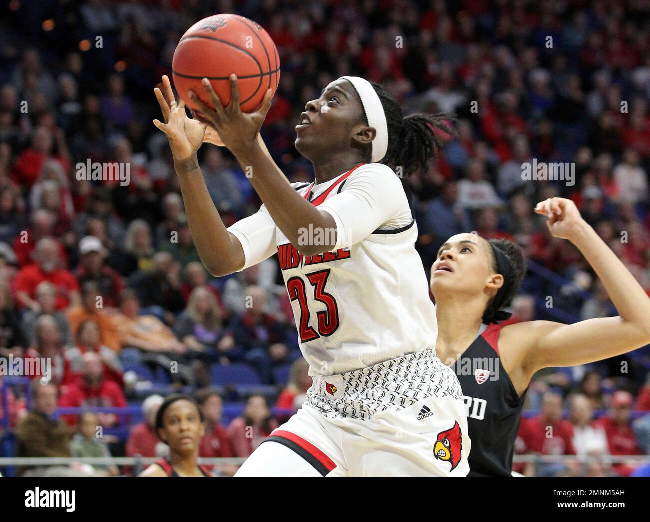 Louisville's Jazmine Jones (23) shoots near Stanford's Kaylee Johnson ...