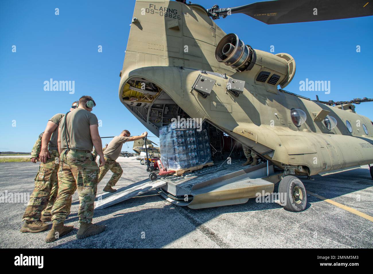 Florida Army National Guard Soldiers load a pallet of water into a ...