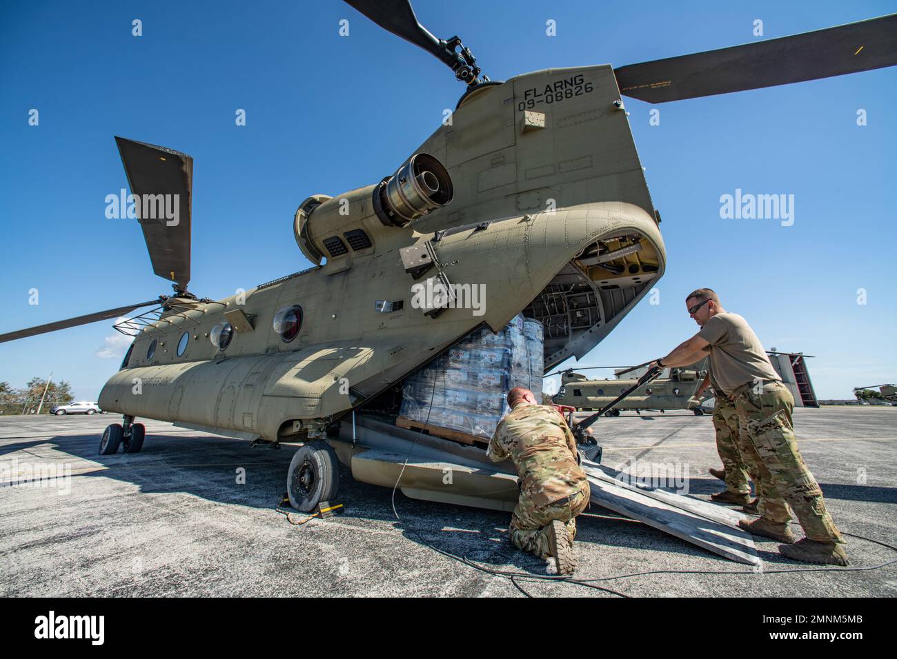 Florida Army National Guard Soldiers load a pallet of water into a ...