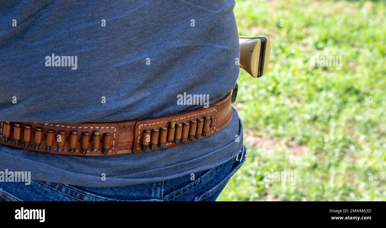 A hand made leather ammo belt is worn around an unidentified man's ...