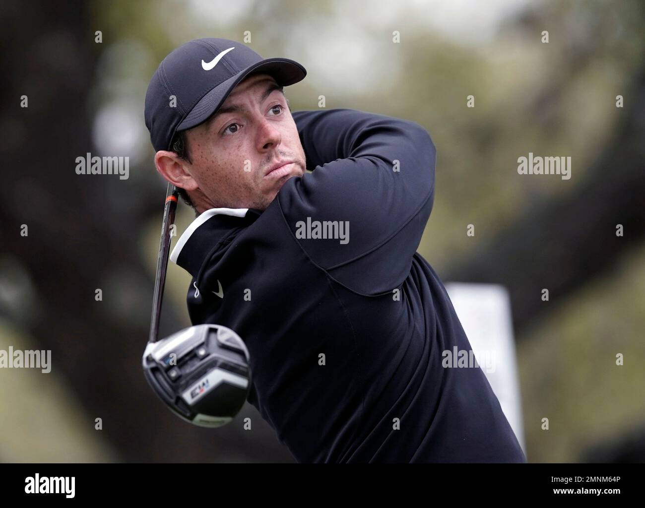 Rory McIlroy watches his drive from the first tee during round-robin ...