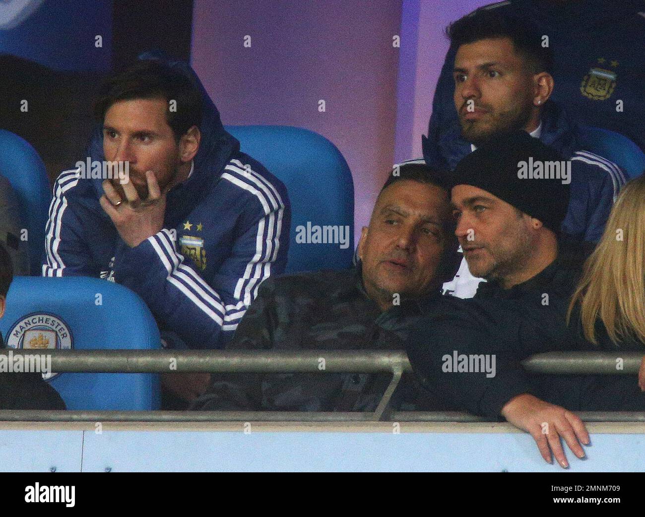 Argentina's Lionel Messi, left, and Sergio Aguero, top right, sit on ...