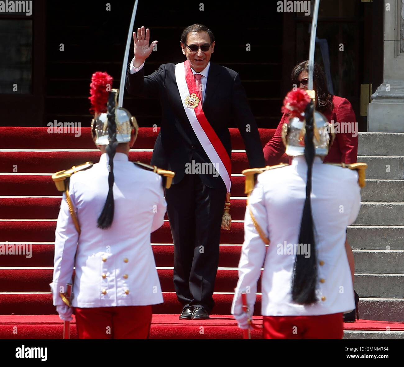 Peru's President Martin Vizcarra, wearing the presidential sash, waves ...