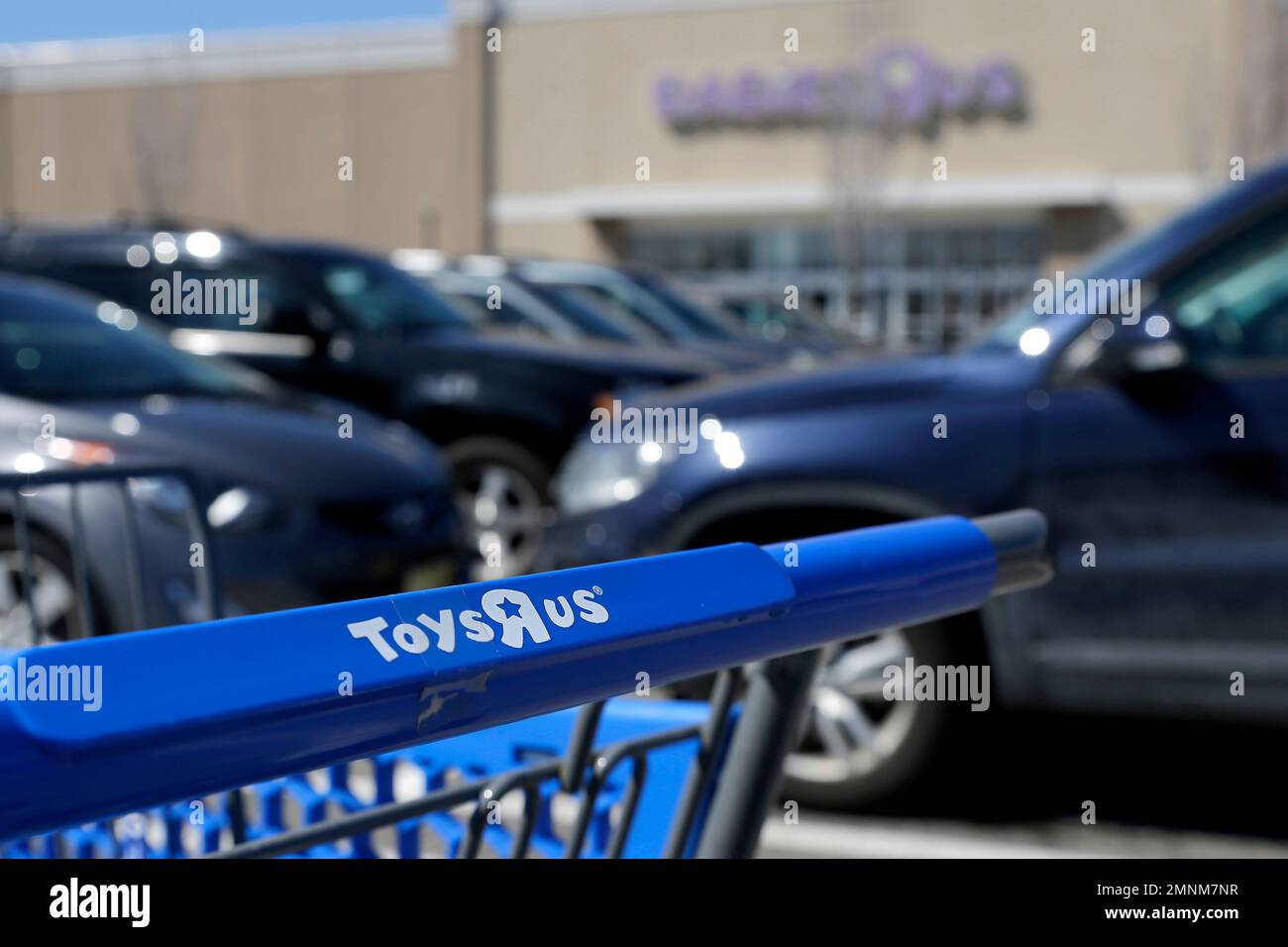 A Toys R Us shopping cart is seen in the parking lot of a Babies R Us ...