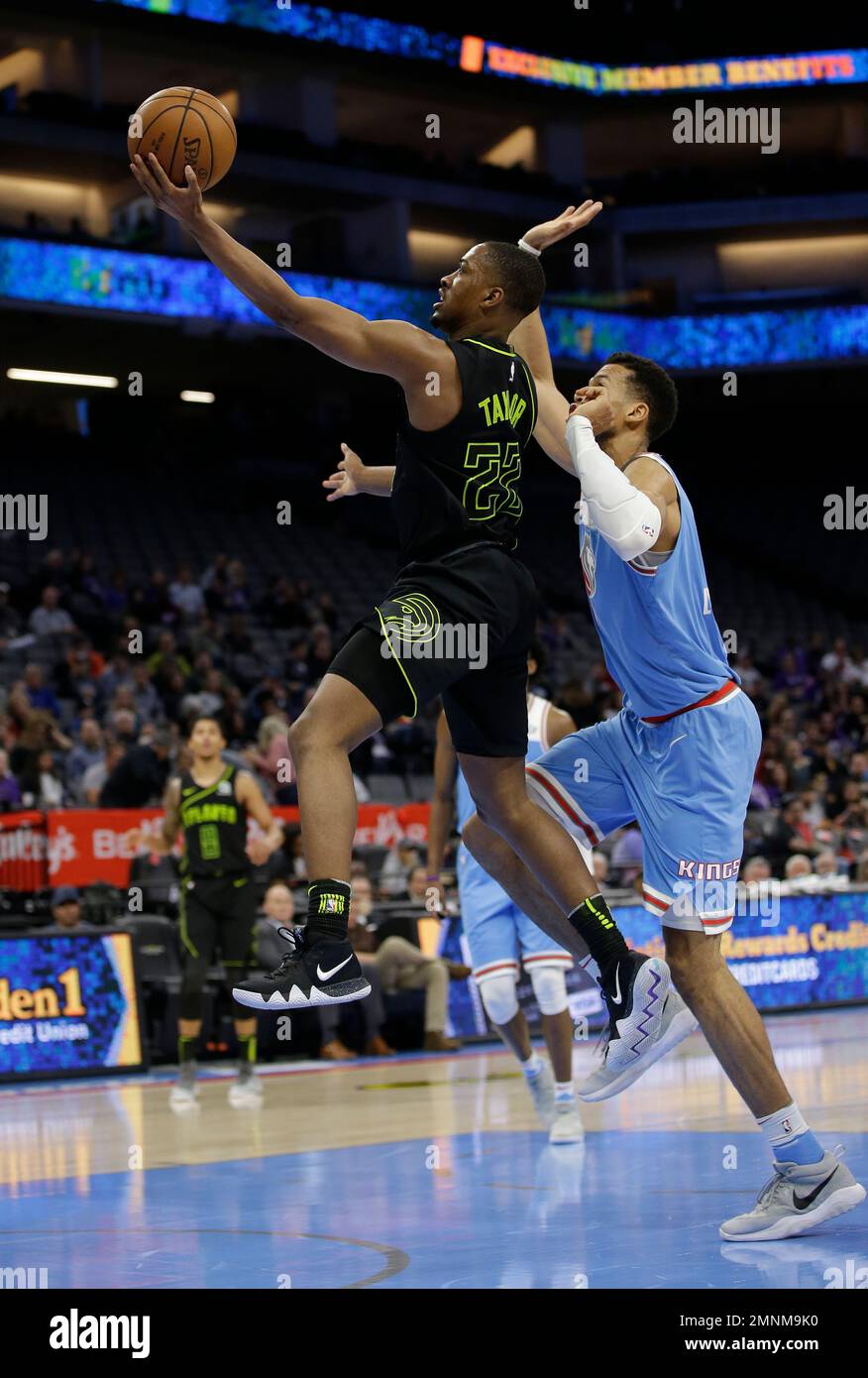 Atlanta Hawks guard Isaiah Taylor, left, goes to the basket past ...