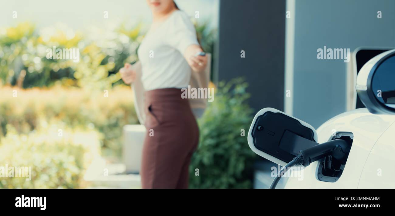 Focus EV charger plugged into EV car at home charging station with ...