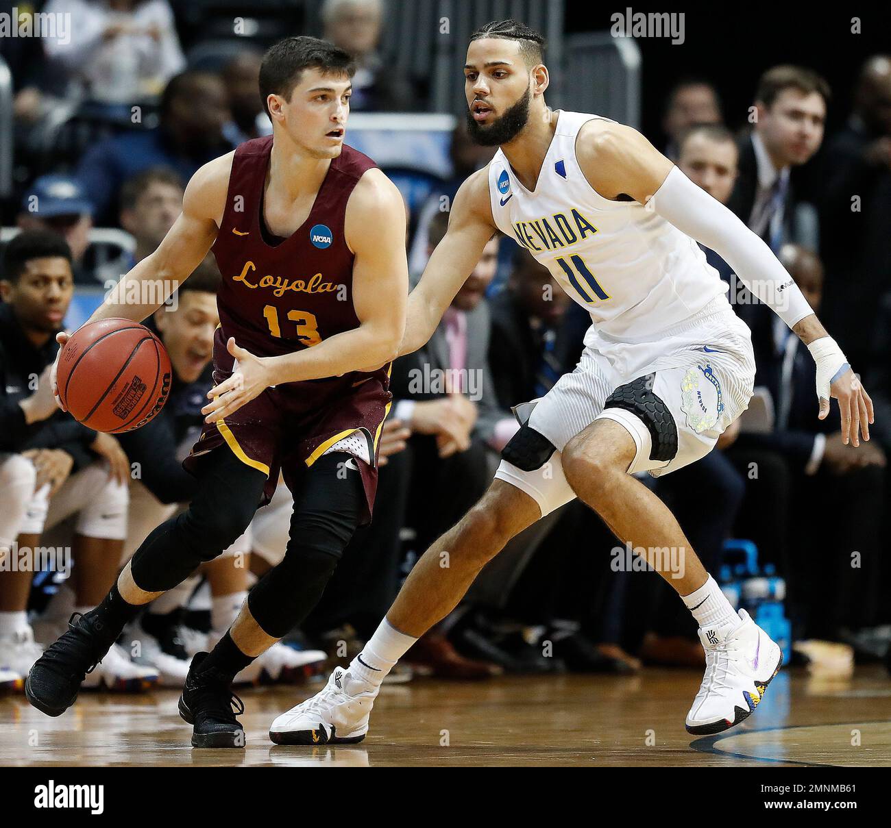 Loyola-Chicago guard Clayton Custer (13) drives against Nevada forward ...