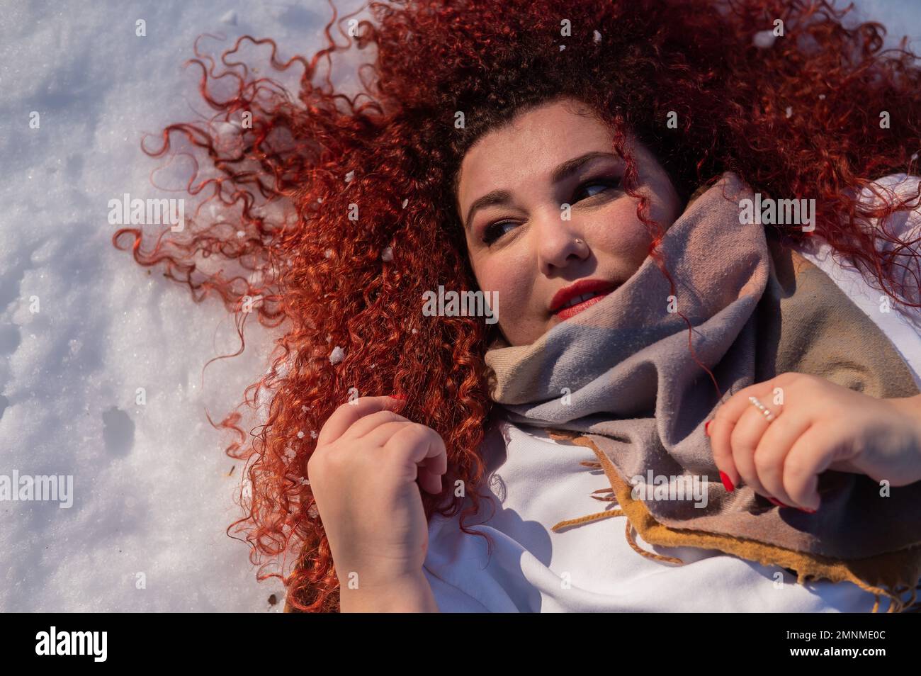 Top view of a fat red-haired woman lying on the snow Stock Photo - Alamy