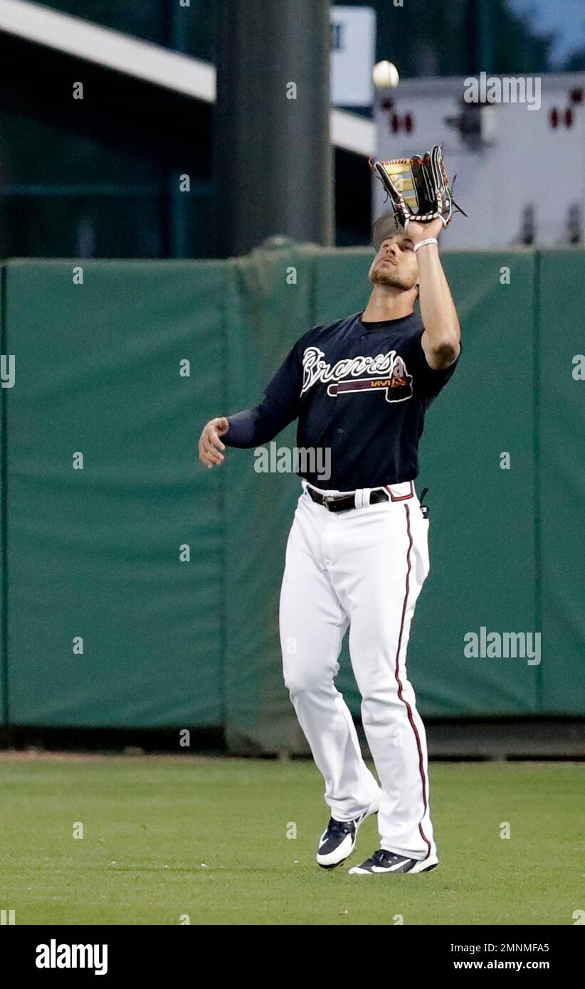 Atlanta Braves outfielder Lane Adams catches a fly ball in right field ...