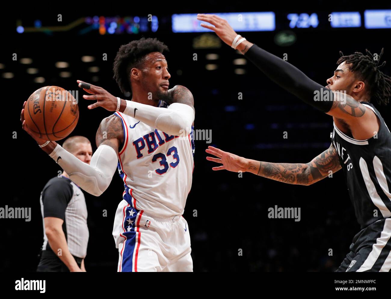 Philadelphia 76ers forward Robert Covington (33) passes around Brooklyn ...