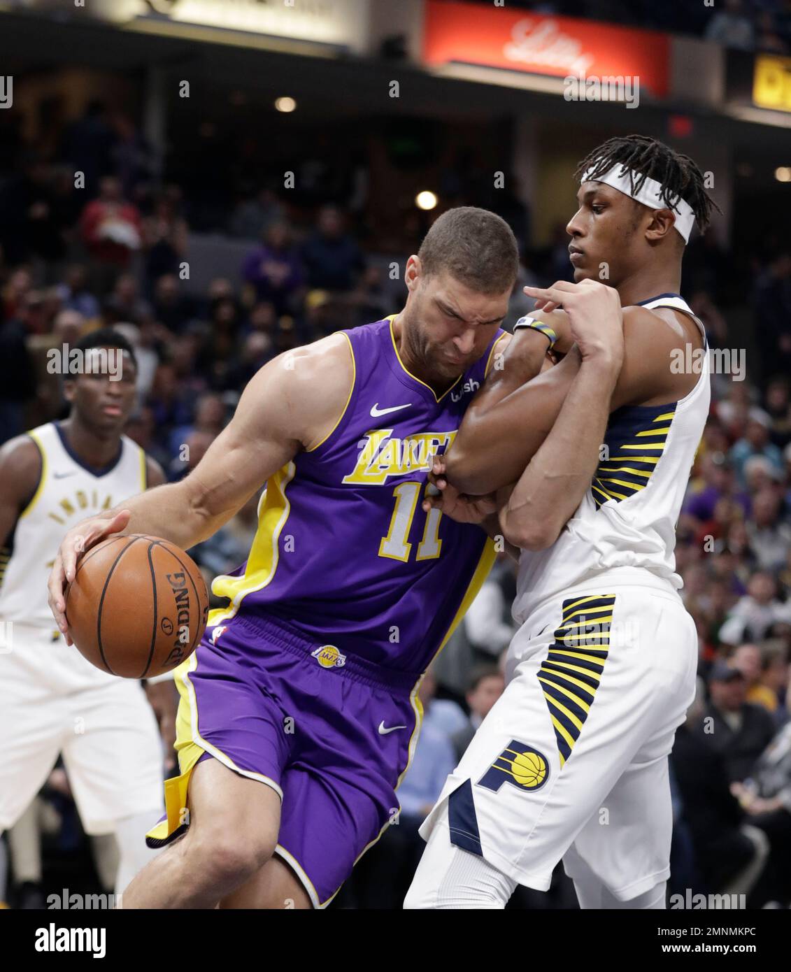 Los Angeles Lakers' Brook Lopez is defended by Indiana Pacers' Myles ...