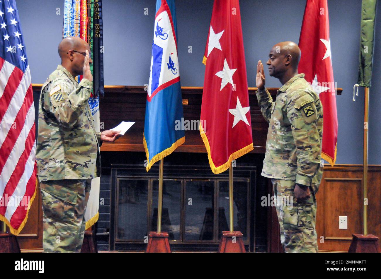 Lt. Gen. Milford H. Beagle Jr. (right) recites the oath of enlistment ...