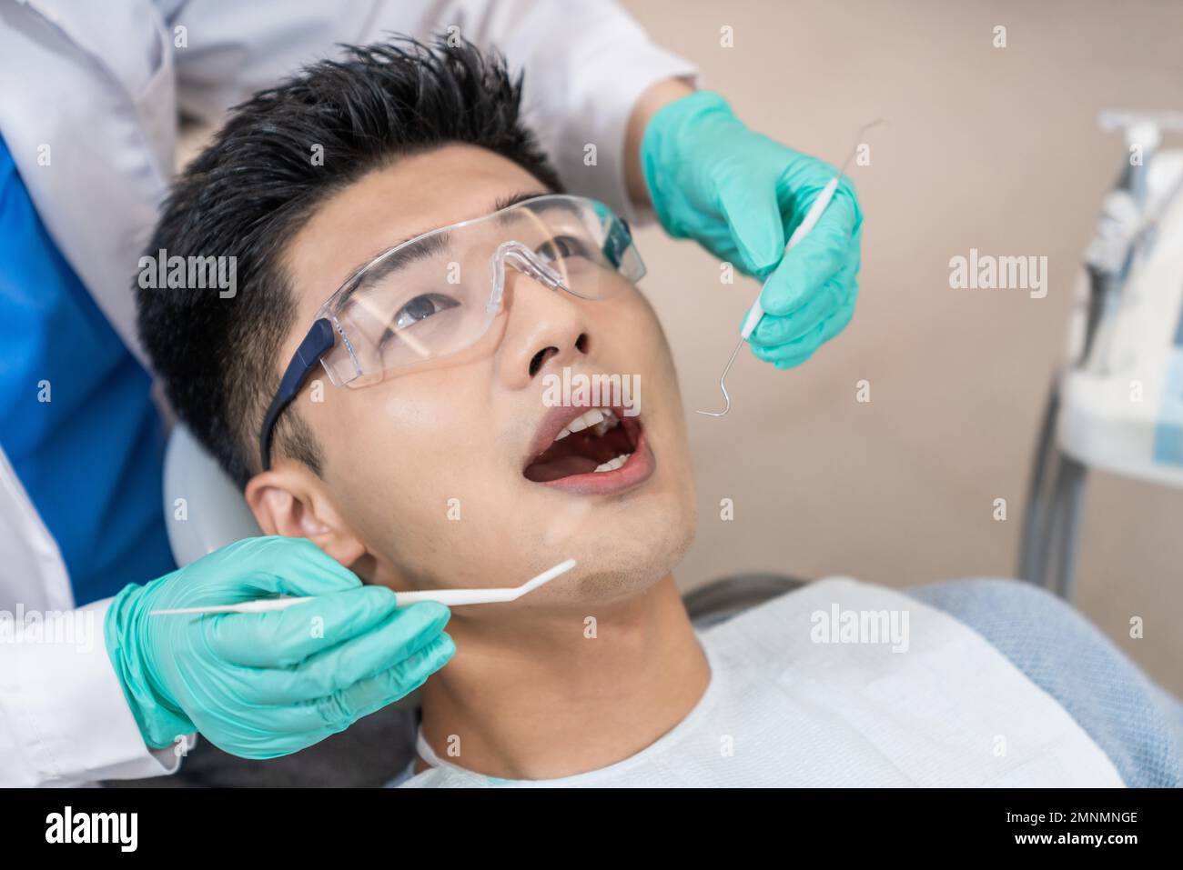 A young man in the dental clinic treatment teeth Stock Photo - Alamy