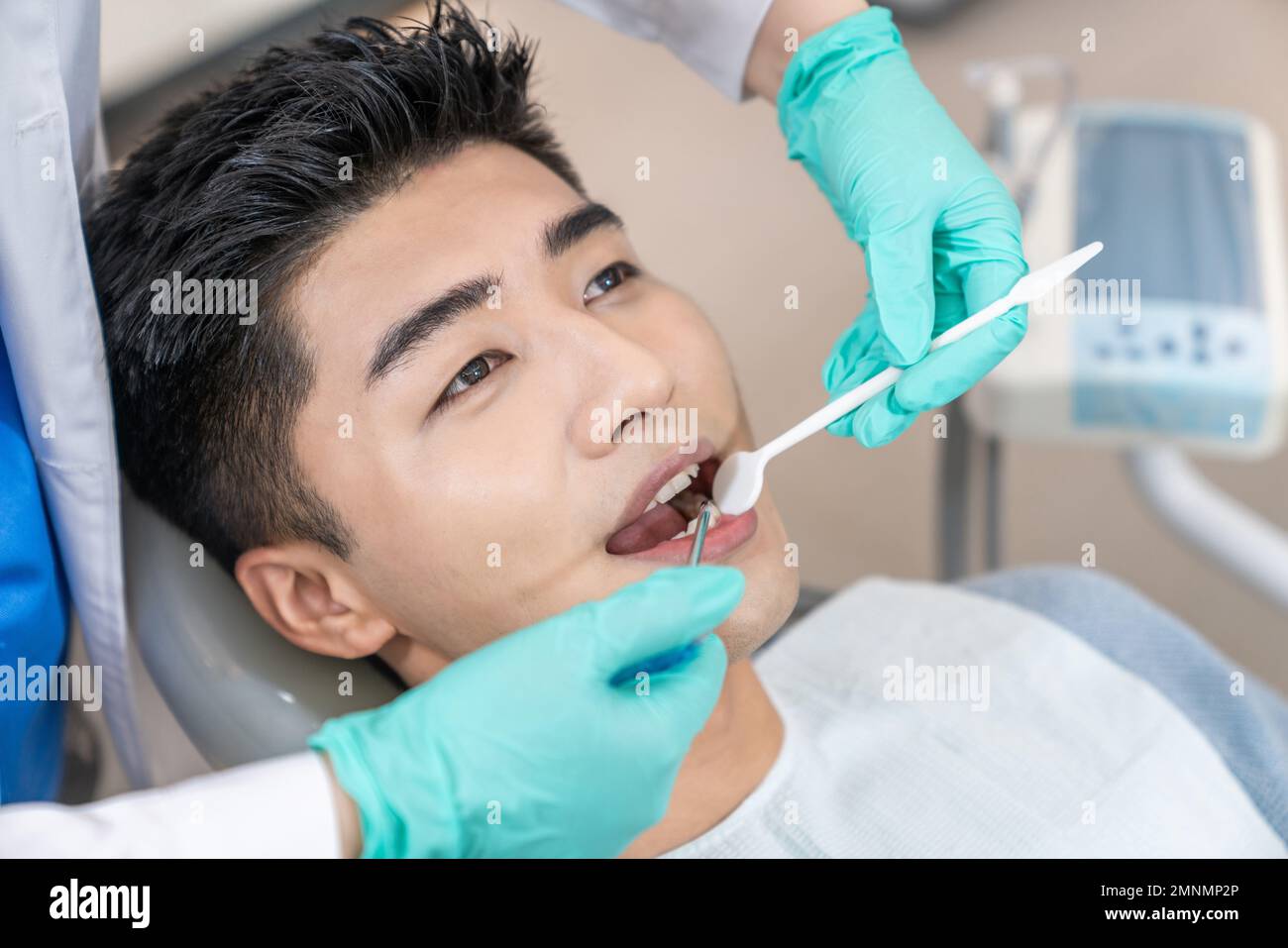 A young man in the dental clinic treatment teeth Stock Photo - Alamy