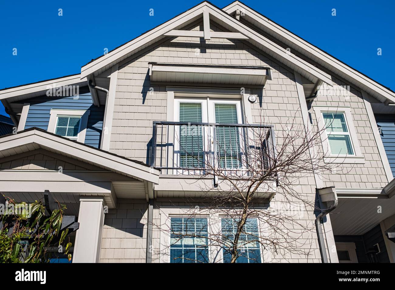 Top of a house with nice windows. Dormer in the blue sky background ...