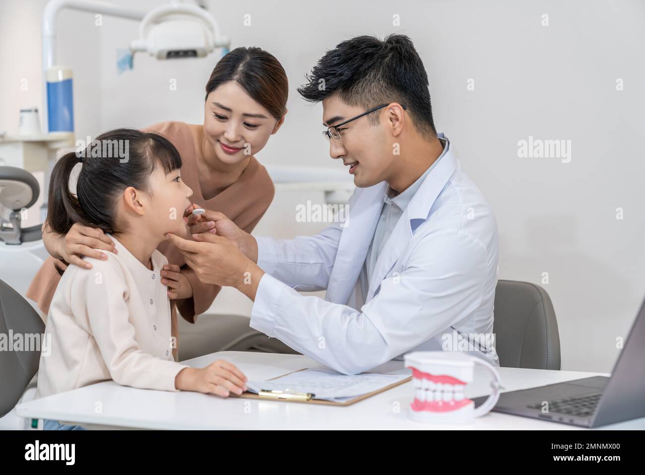 Mother with her two daughters in dental clinic Stock Photo - Alamy